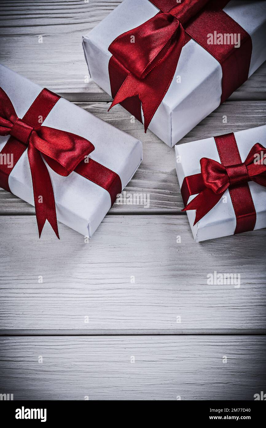 Present boxes with tied ribbons on wooden board holidays concept Stock ...