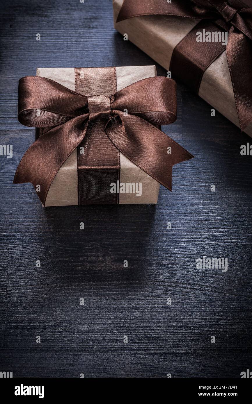 Present boxes with tied ribbons on vintage wooden surface Stock Photo ...