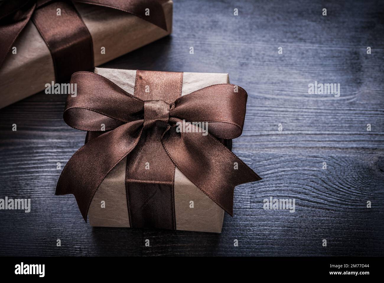 Present boxes with brown tied ribbons on vintage wooden surface Stock ...