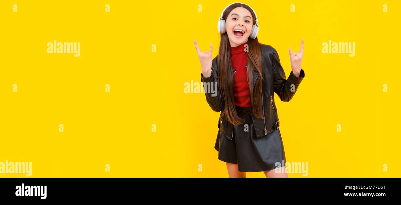 full length of cool child in headphones on yellow background. Child ...