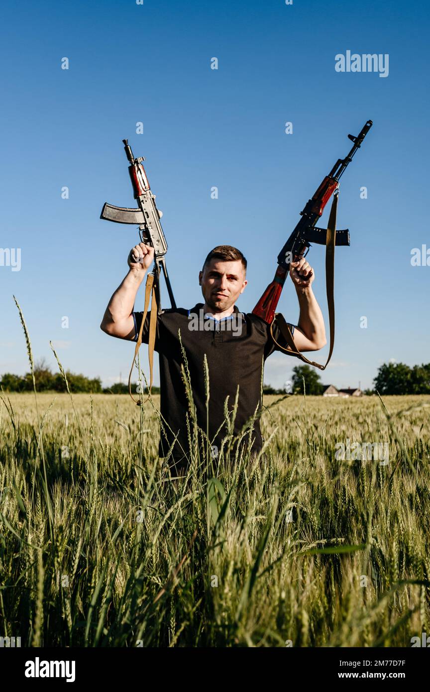 The man in the field with a machine gun, Ukrainian men are preparing ...