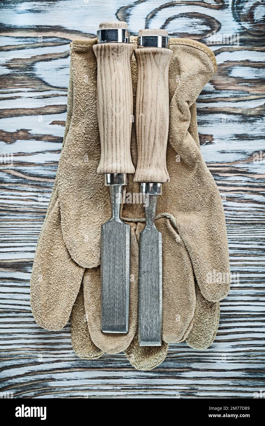 Protective gloves flat chisels on wooden board Stock Photo - Alamy
