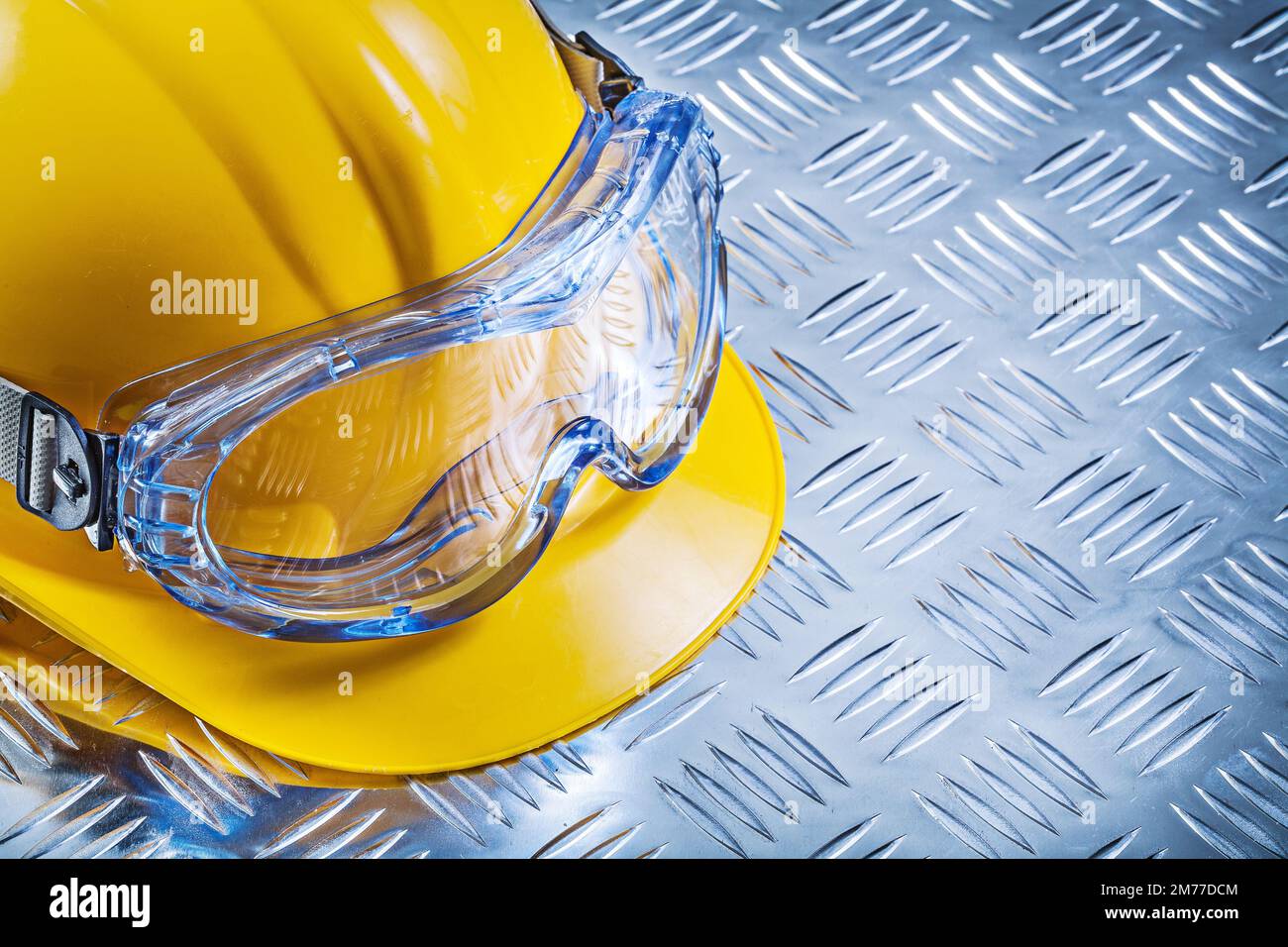 Protective spectacles building helmet on corrugated metal sheet ...