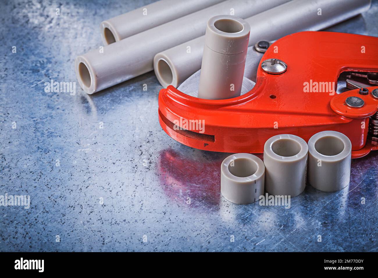Pvc water pipe cutter on metallic background top view construction ...