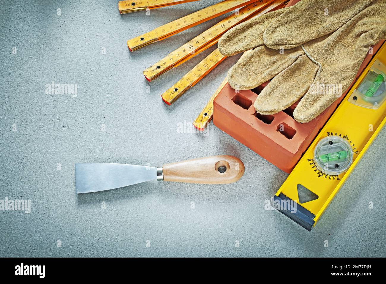 Red brick protective gloves palette knife construction level on ...