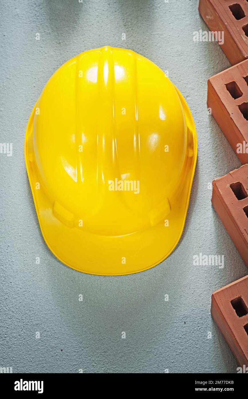 Red bricks safety cap on concrete surface top view construction concept ...