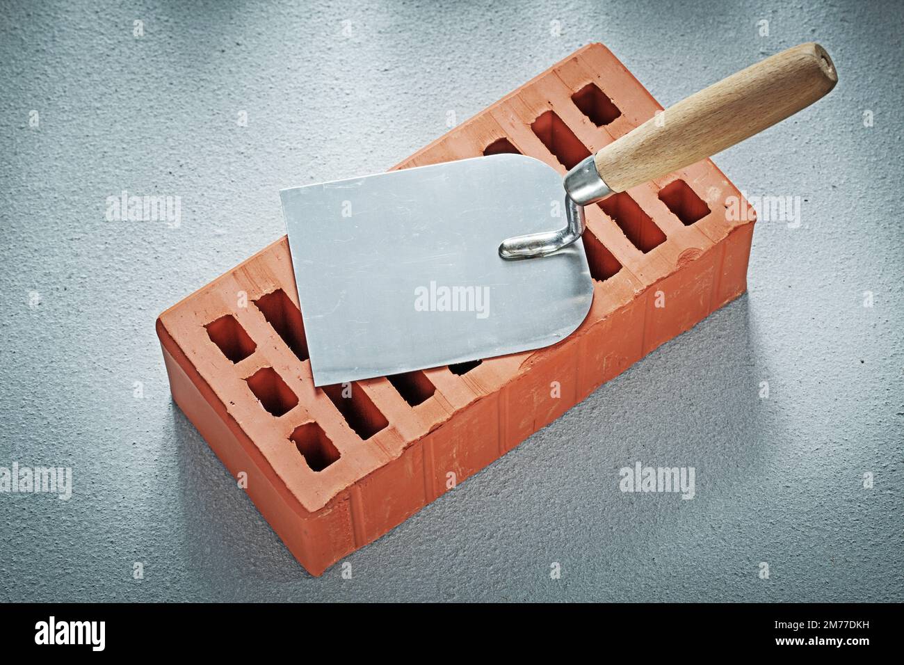Red bricks putty spattle on concrete background bricklaying concept ...