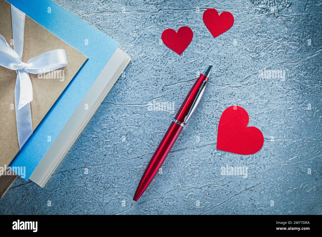 Red hearts biro pen vintage writing books on metallic background ...