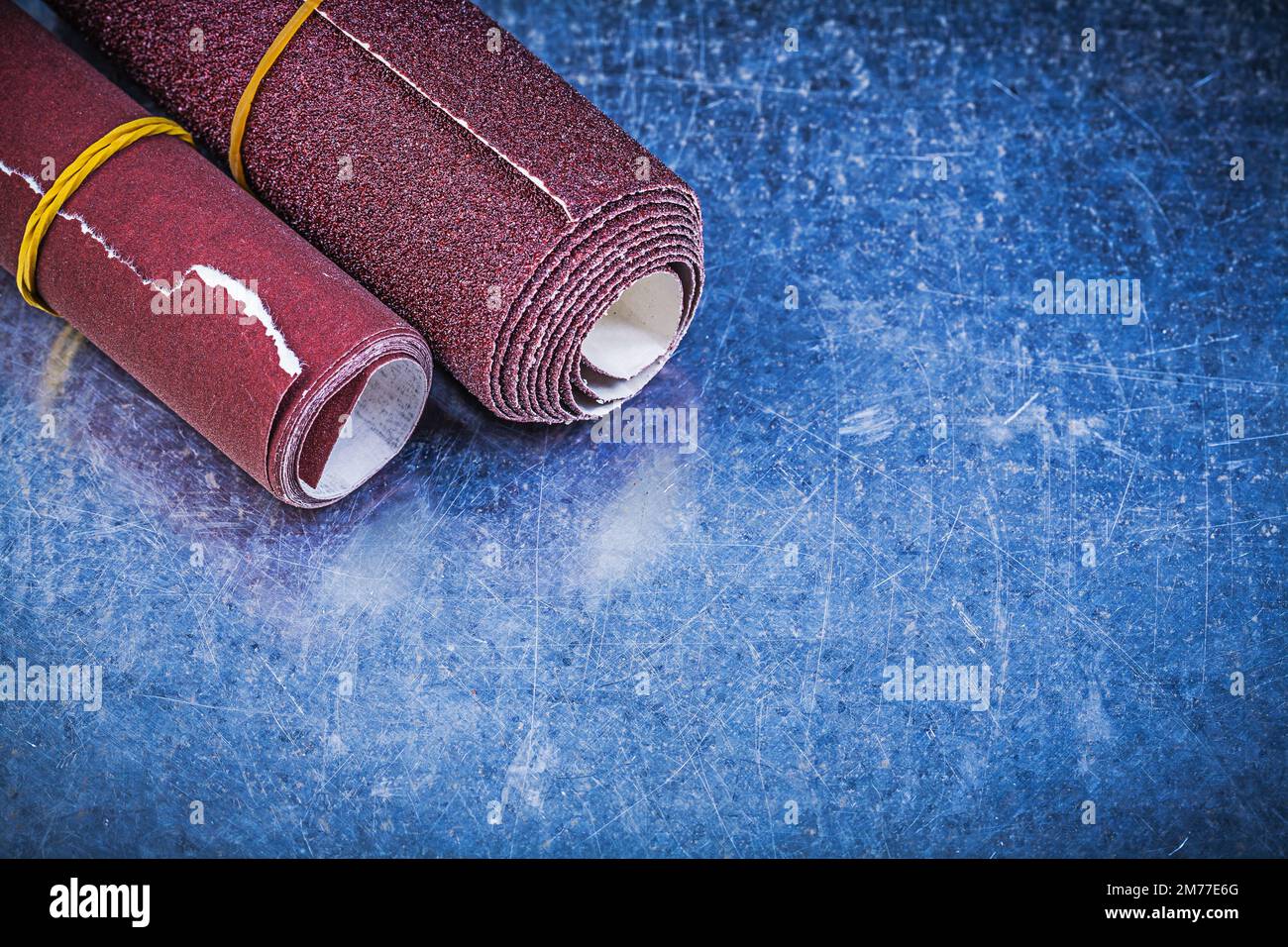 Rolled up polishing paper on metallic background abrasive tools Stock ...