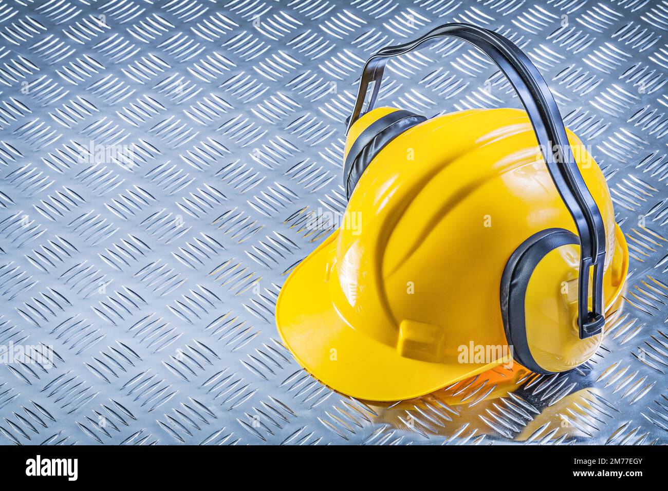 Safety ear muffs building helmet on corrugated metal plate construction ...