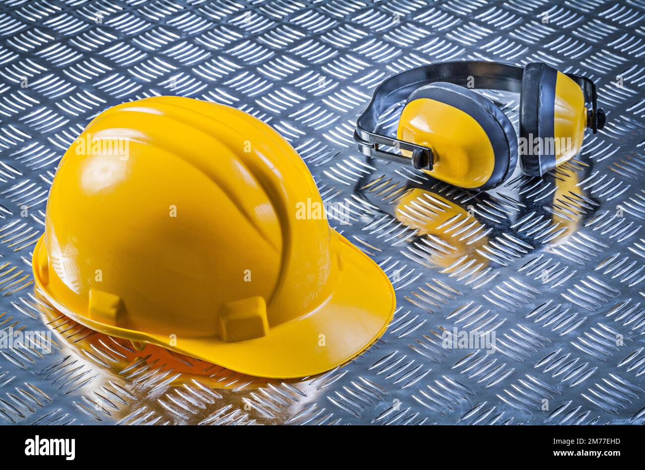 Safety earmuffs hard hat on fluted metal sheet construction concept ...