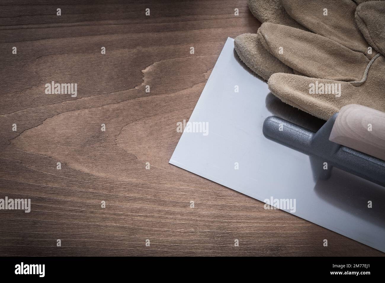Safety gloves and glazed plastering trowel top view construction ...