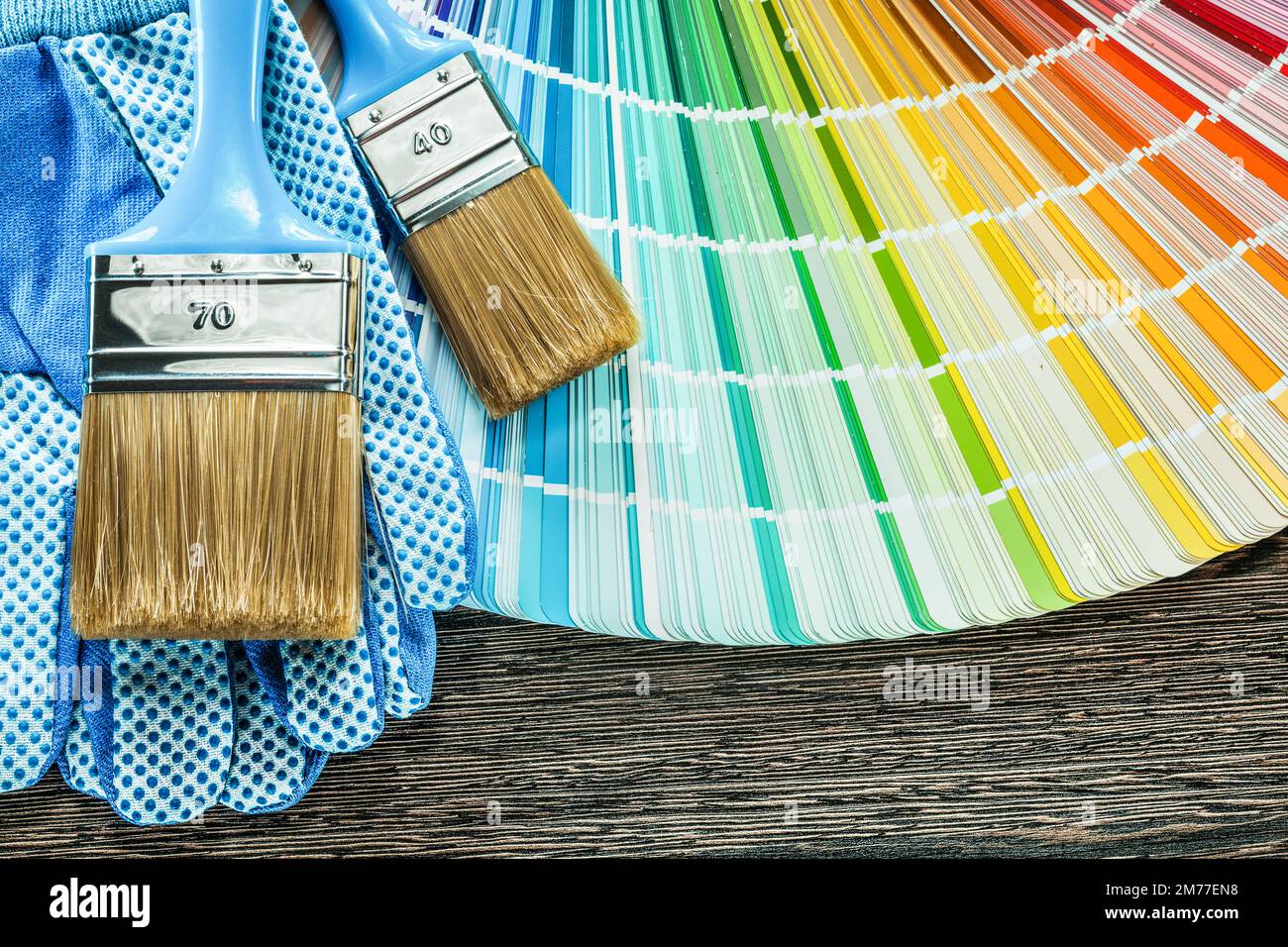 Safety gloves paint brushes color sampler on wooden board Stock Photo ...