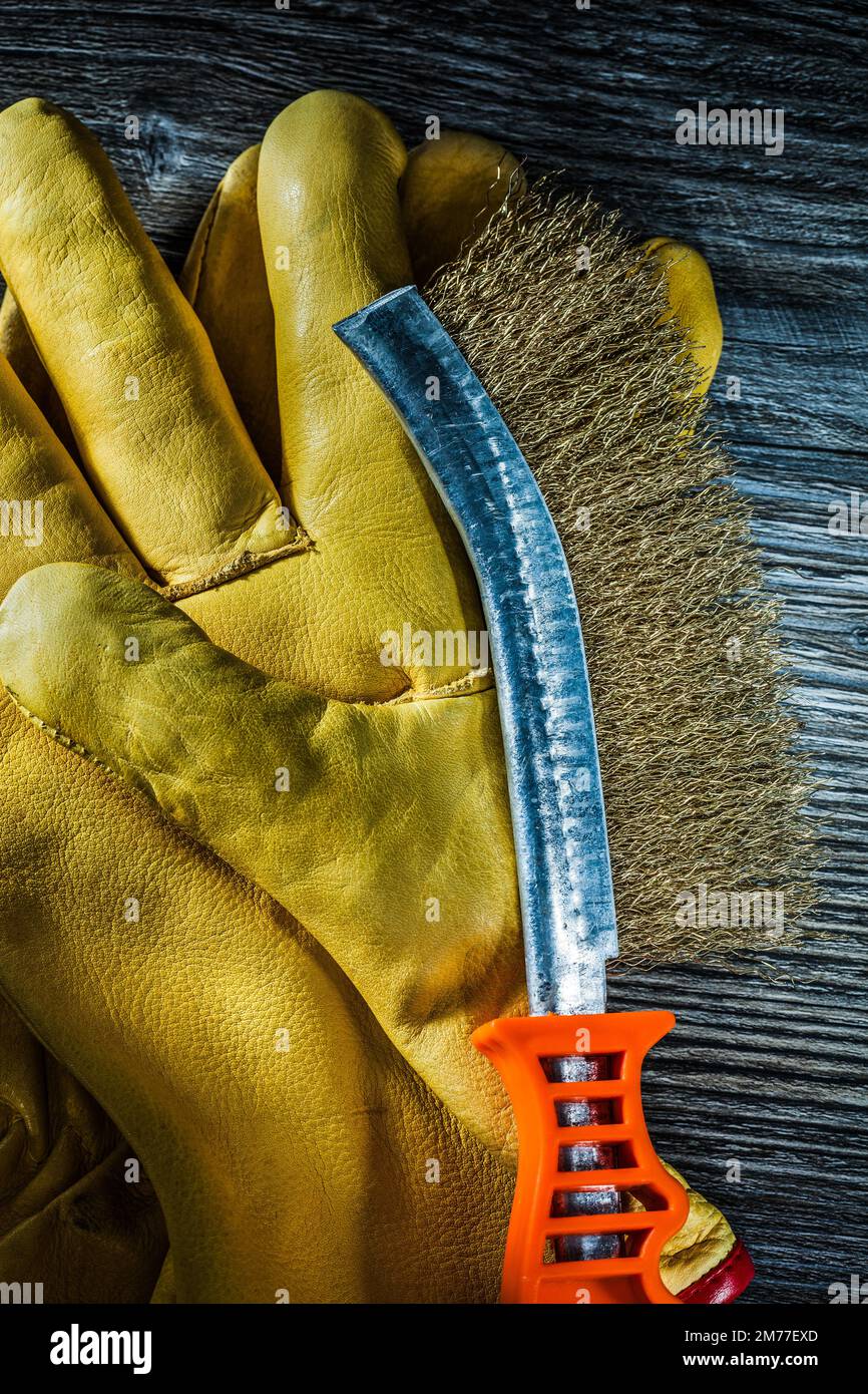 Scratch wire brush leather safety gloves on vintage wooden board Stock ...