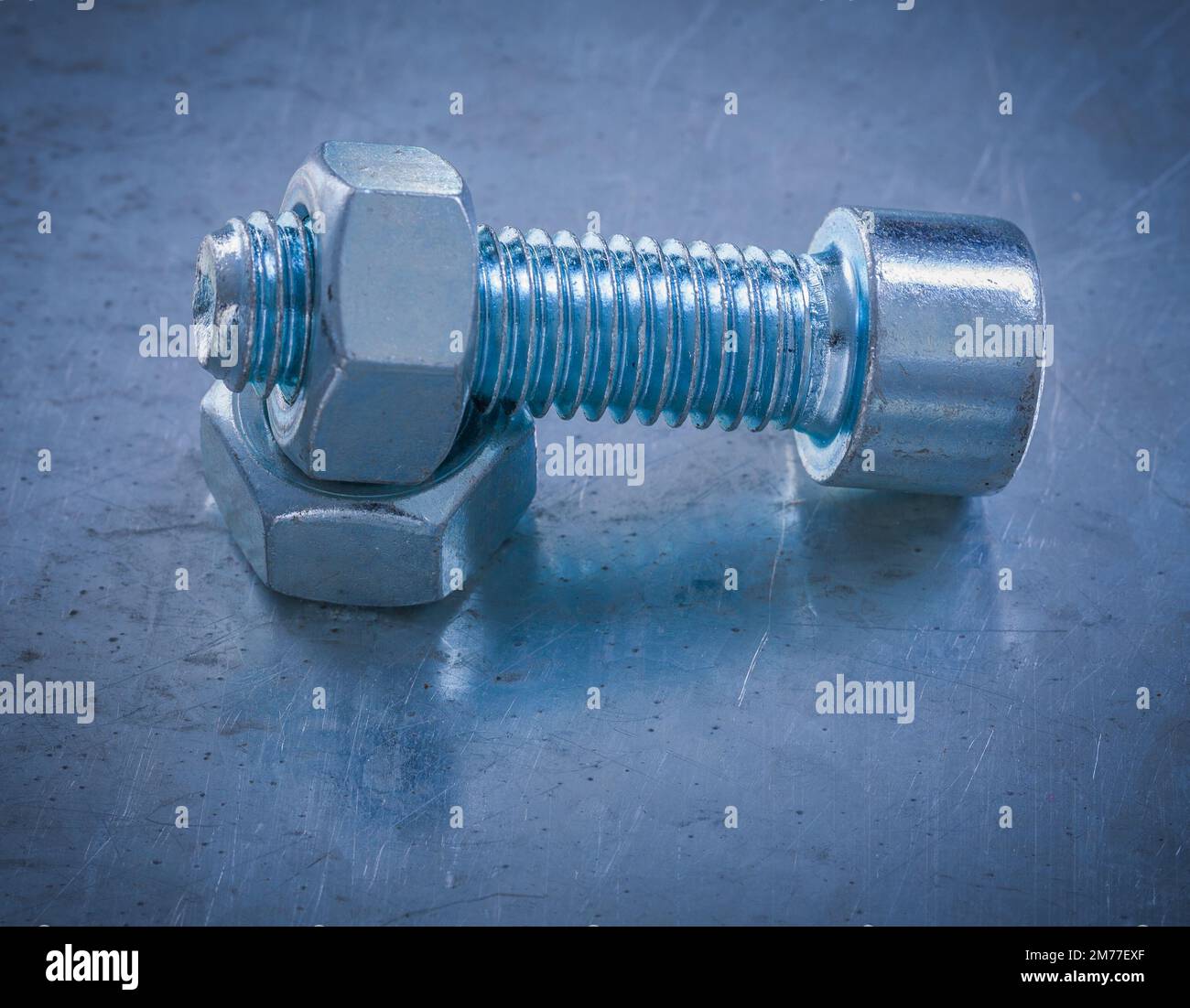 Screwbolt with nuts on scratched metallic surface construction concept ...