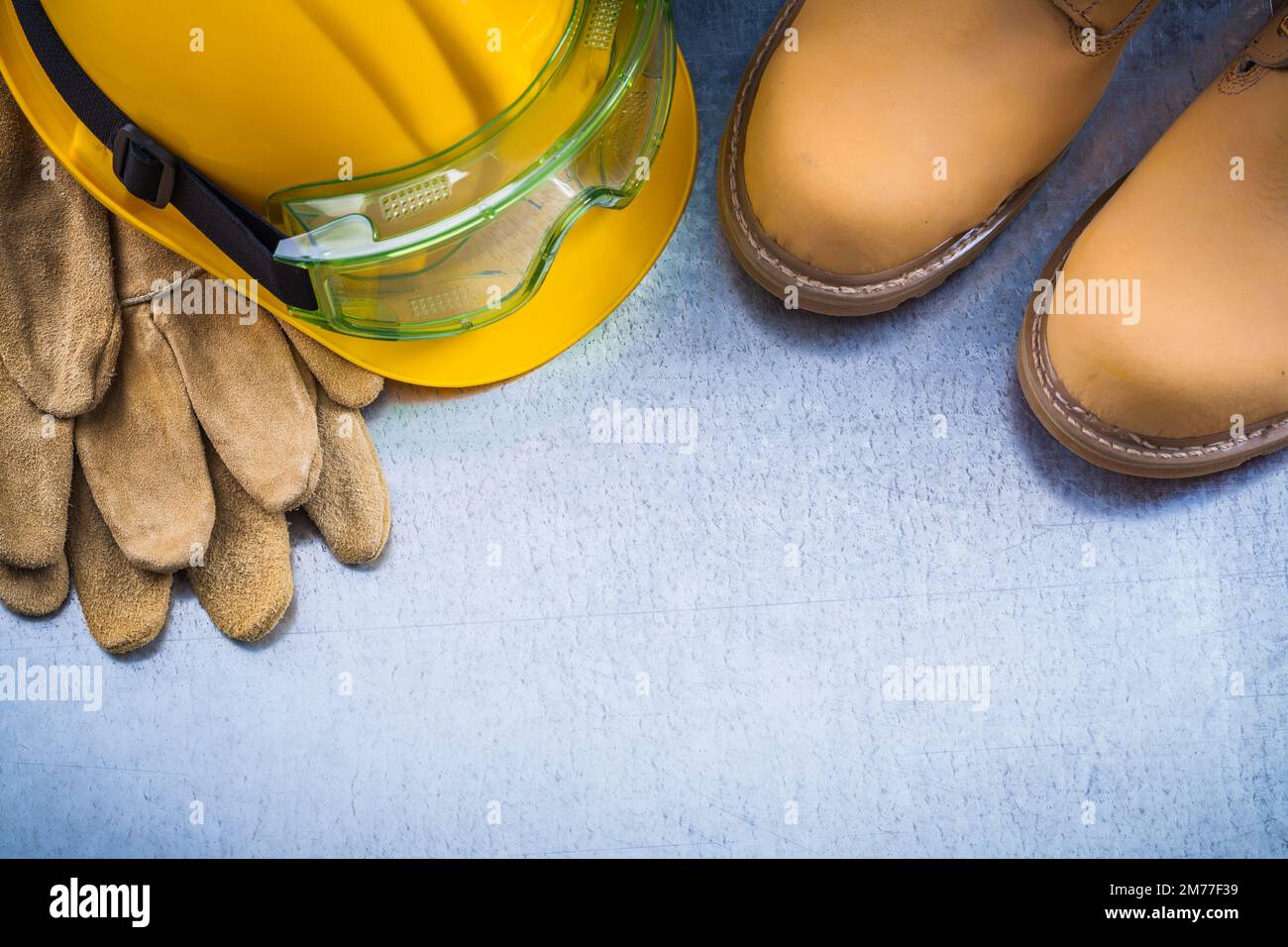 Set of brown safety waterproof shoes leather gloves hard hat and ...