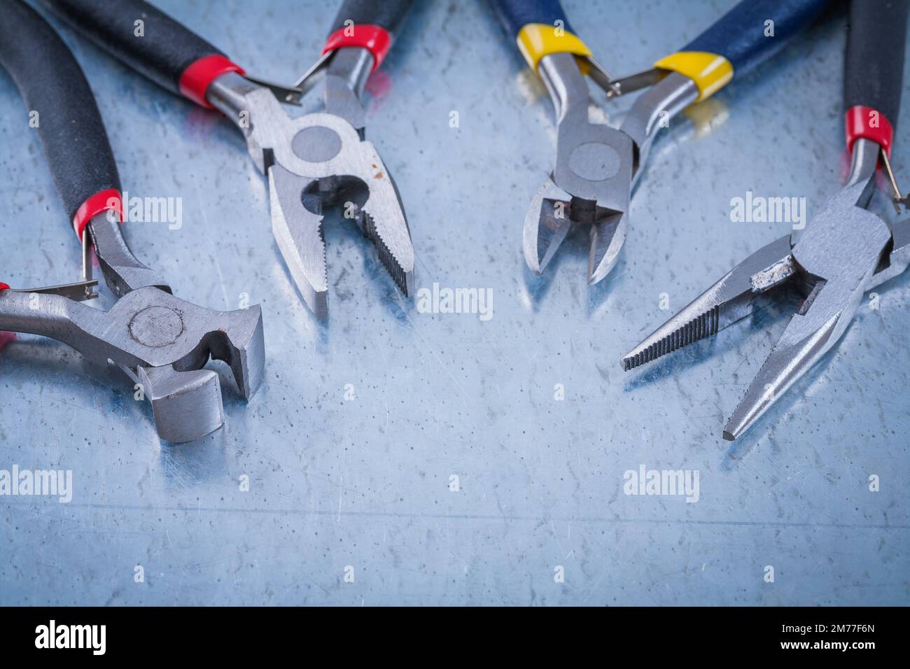 Set of electric metal wire cutters on scratched metallic background ...