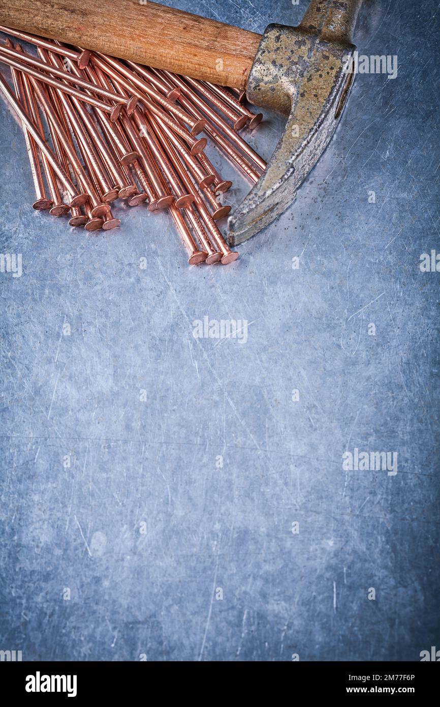 Set of copper construction nails vintage claw hammer on metallic ...