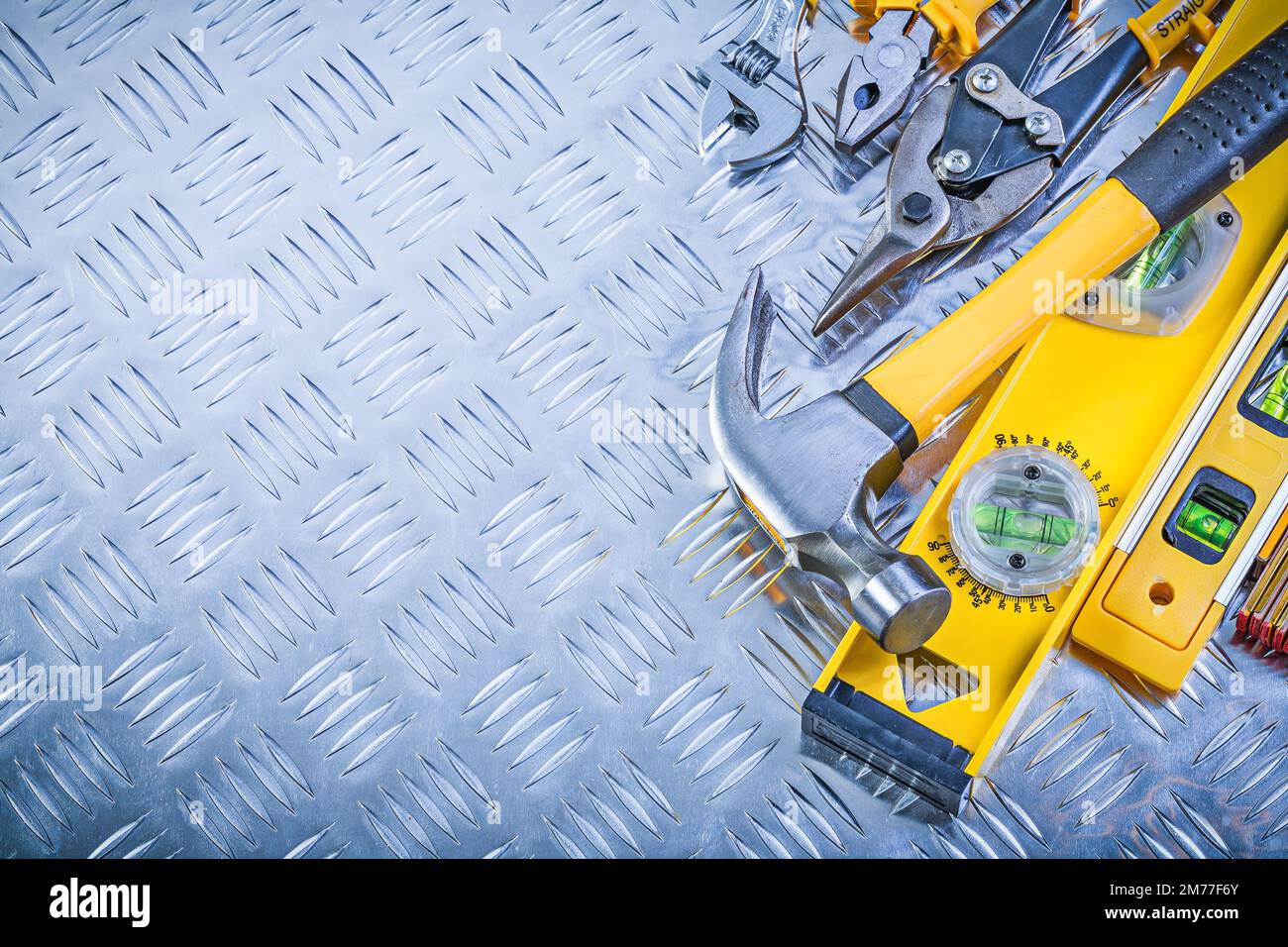 Set of construction tools on grooved metal plate maintenance concept ...