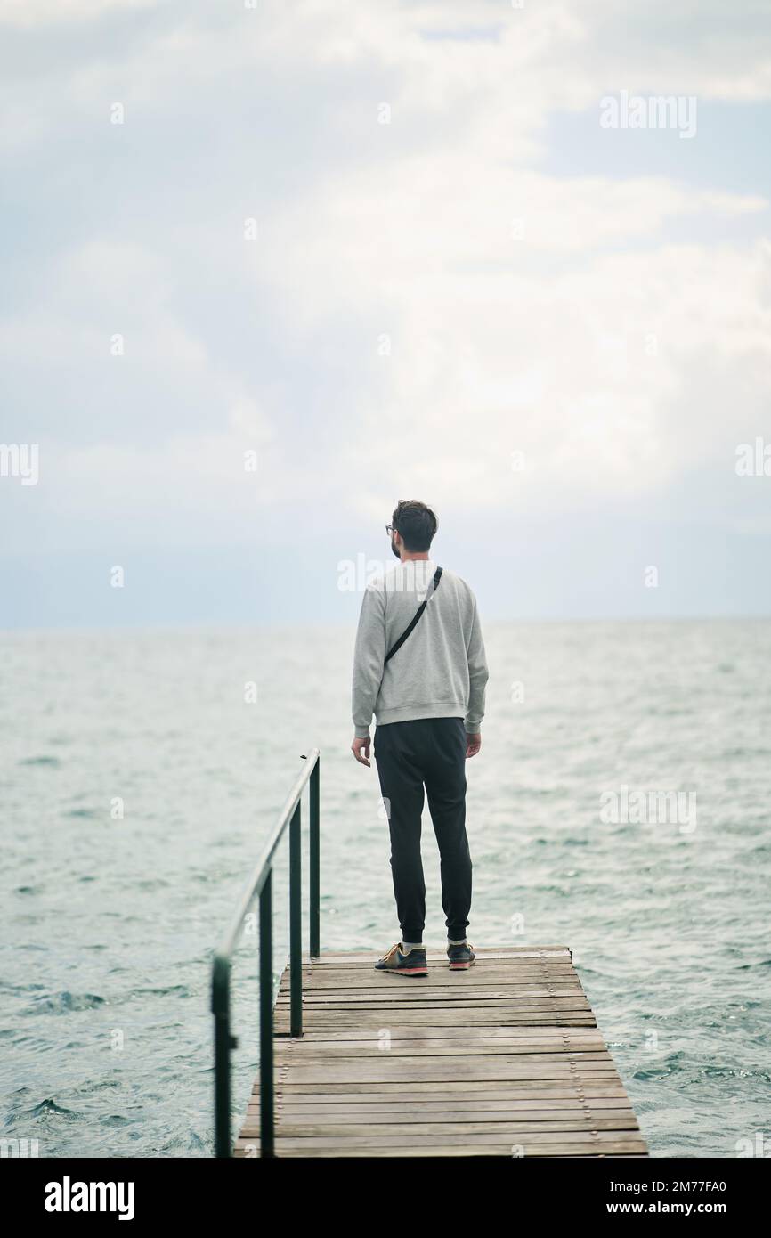 Back view young tourist sitting hi-res stock photography and images - Alamy