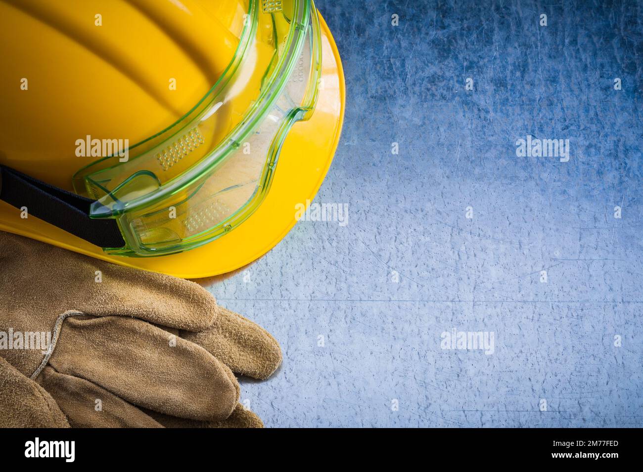 Set of safety workwear on scratched metallic background copy space ...