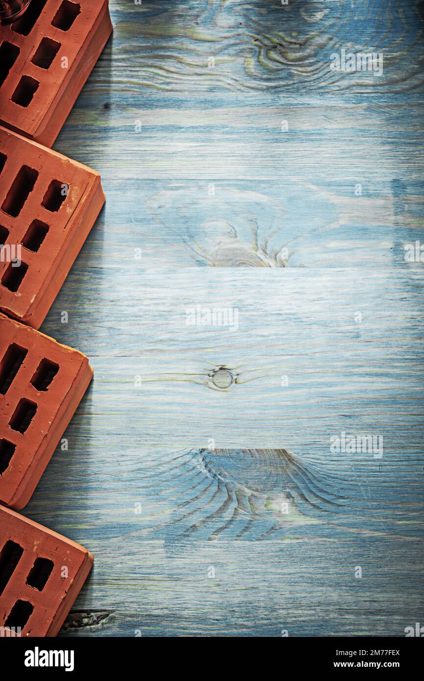 Set of red construction bricks on wood board bricklaying concept Stock ...