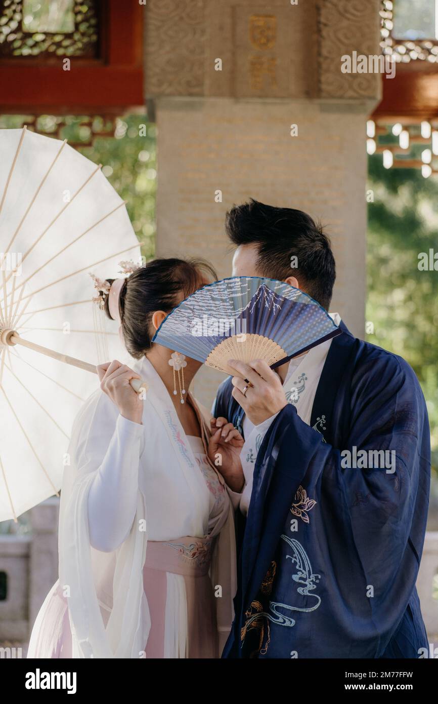 A vertical shot of a bride and a groom kissing each other Stock Photo ...