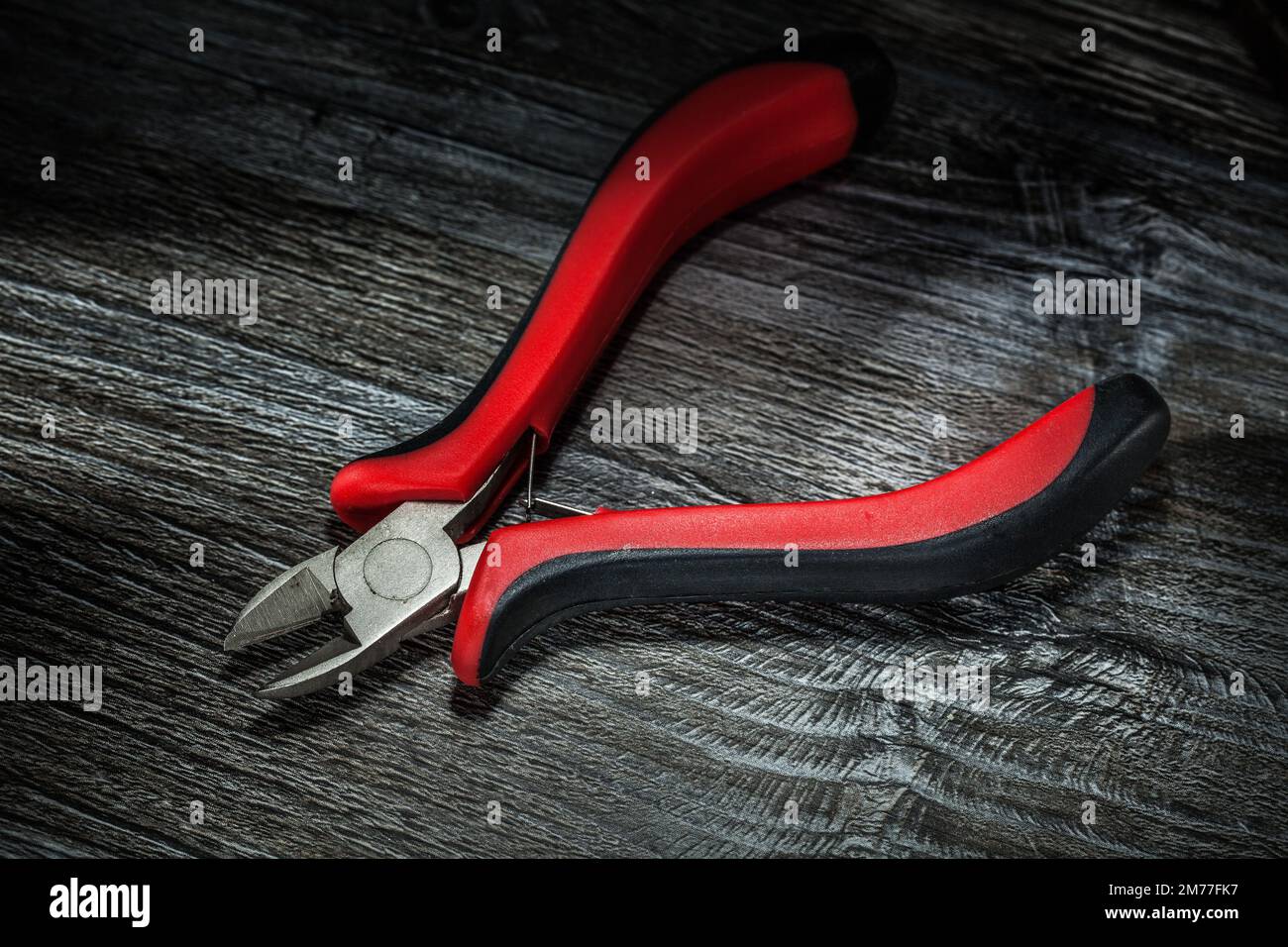 Sharp cutting pliers on wooden board Stock Photo - Alamy