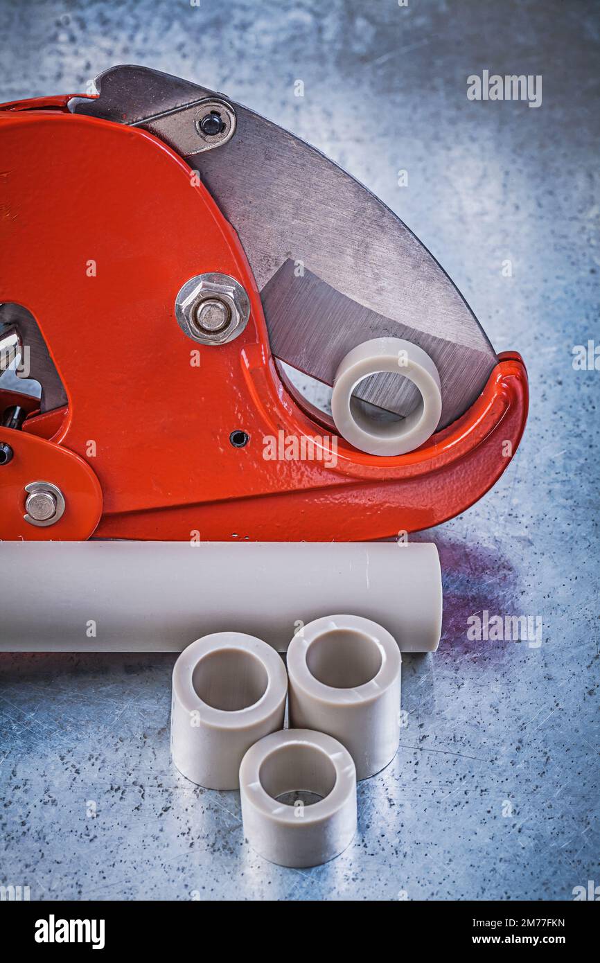 Sharp pipe cutter water tubes on scratched metallic background ...