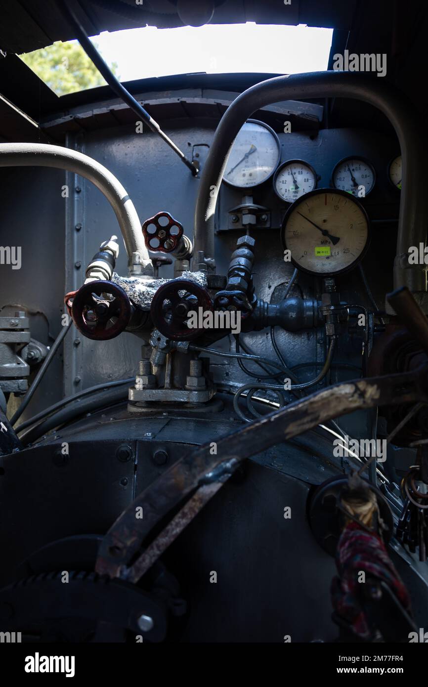A set of pressure gauges and other gauges on a steam locomotive boiler ...