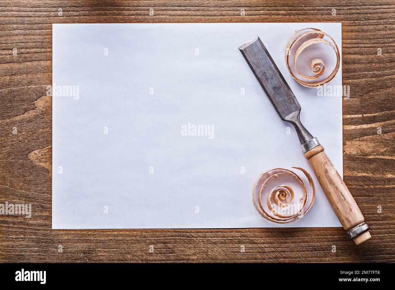 Sheet of paper curled shavings flat chisels construction concept Stock ...