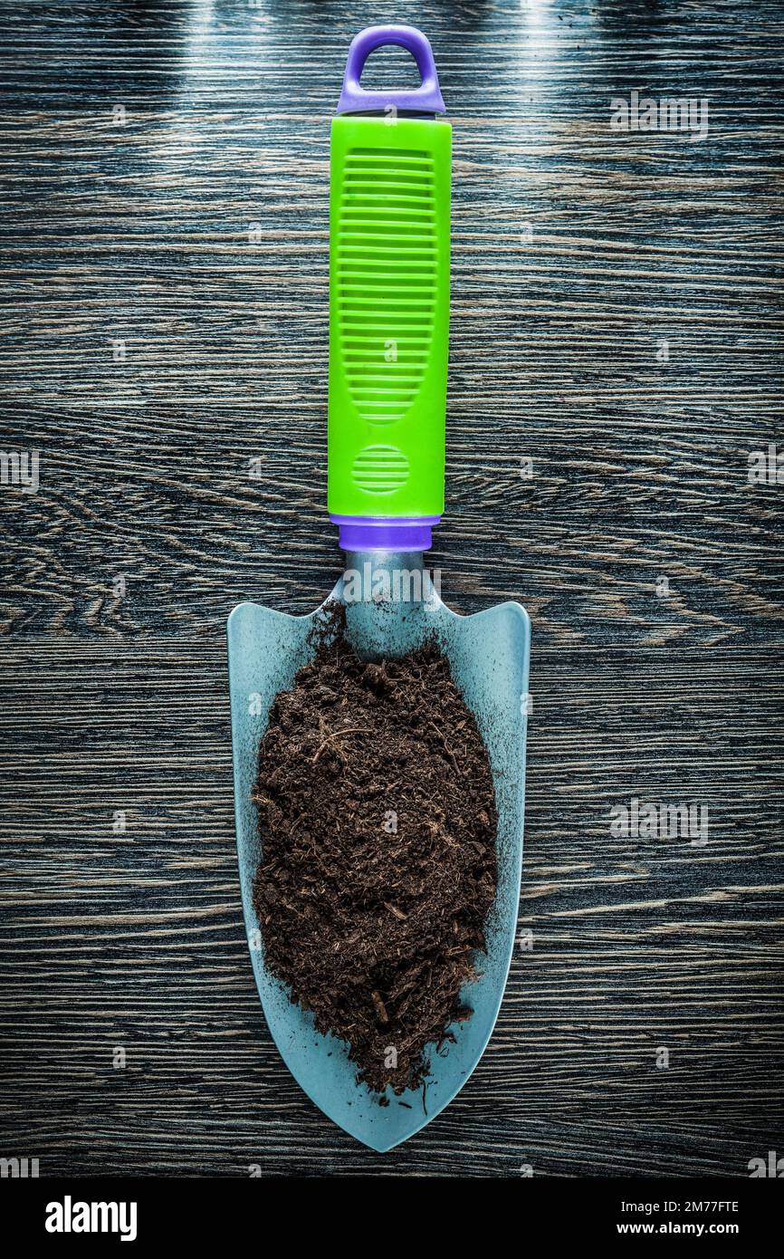 Shovel soil on wooden board agriculture concept Stock Photo - Alamy
