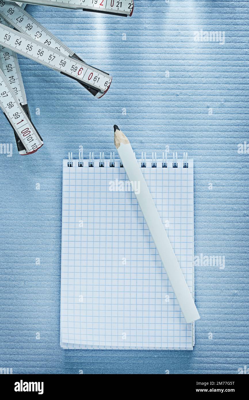 Spiral notepad pencil tape measure construction concept Stock Photo - Alamy
