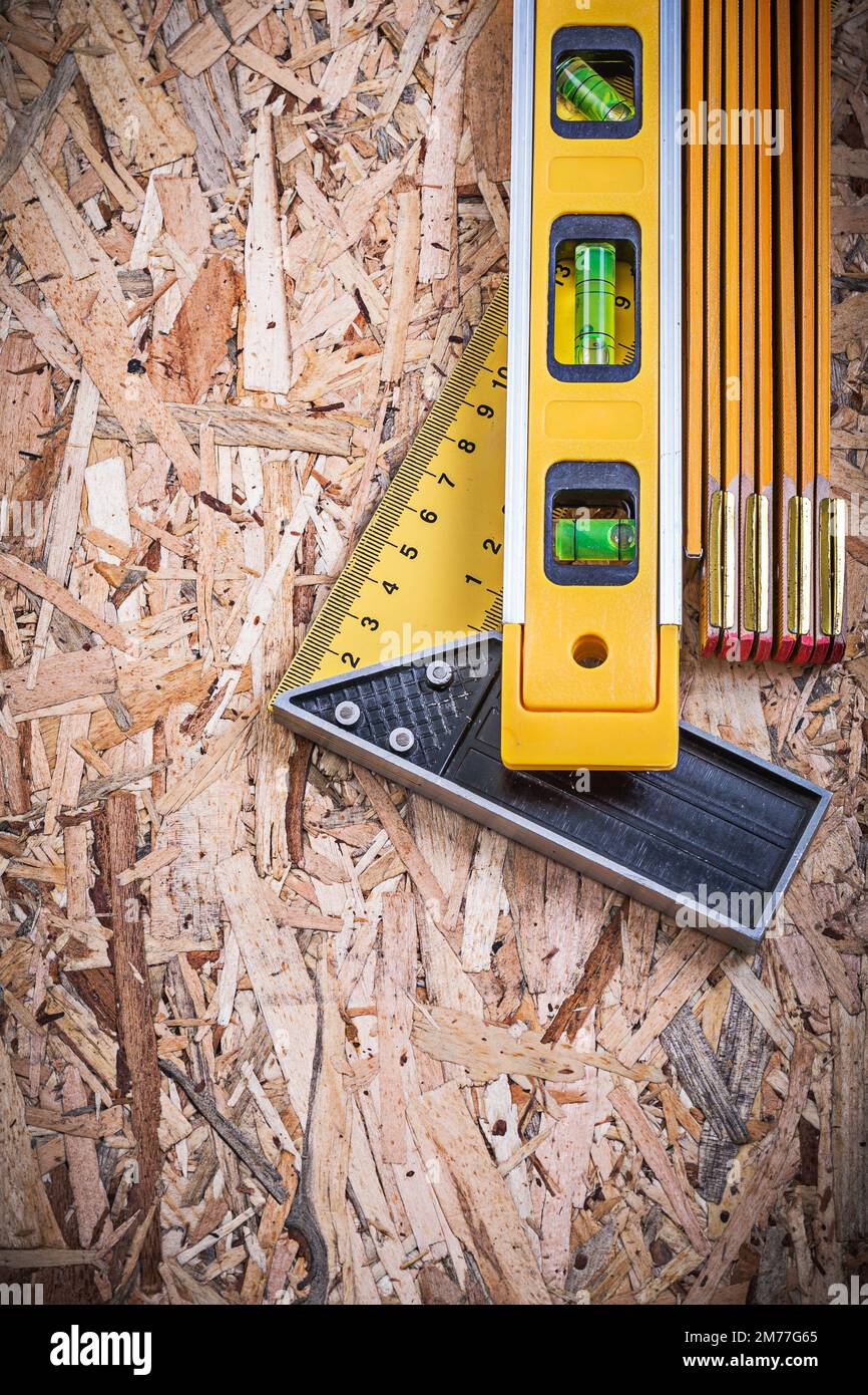 Square ruler construction level wooden meter on chipboard Stock Photo ...