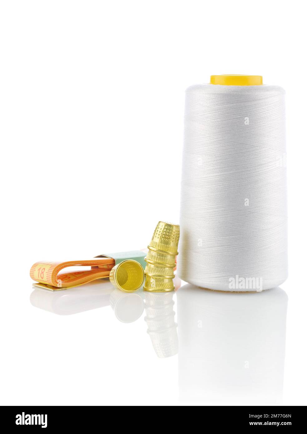 spool of thread with timbles and tapeline Stock Photo - Alamy