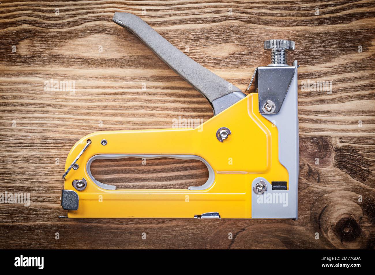 Stapler gun on wooden board maintenance concept Stock Photo - Alamy