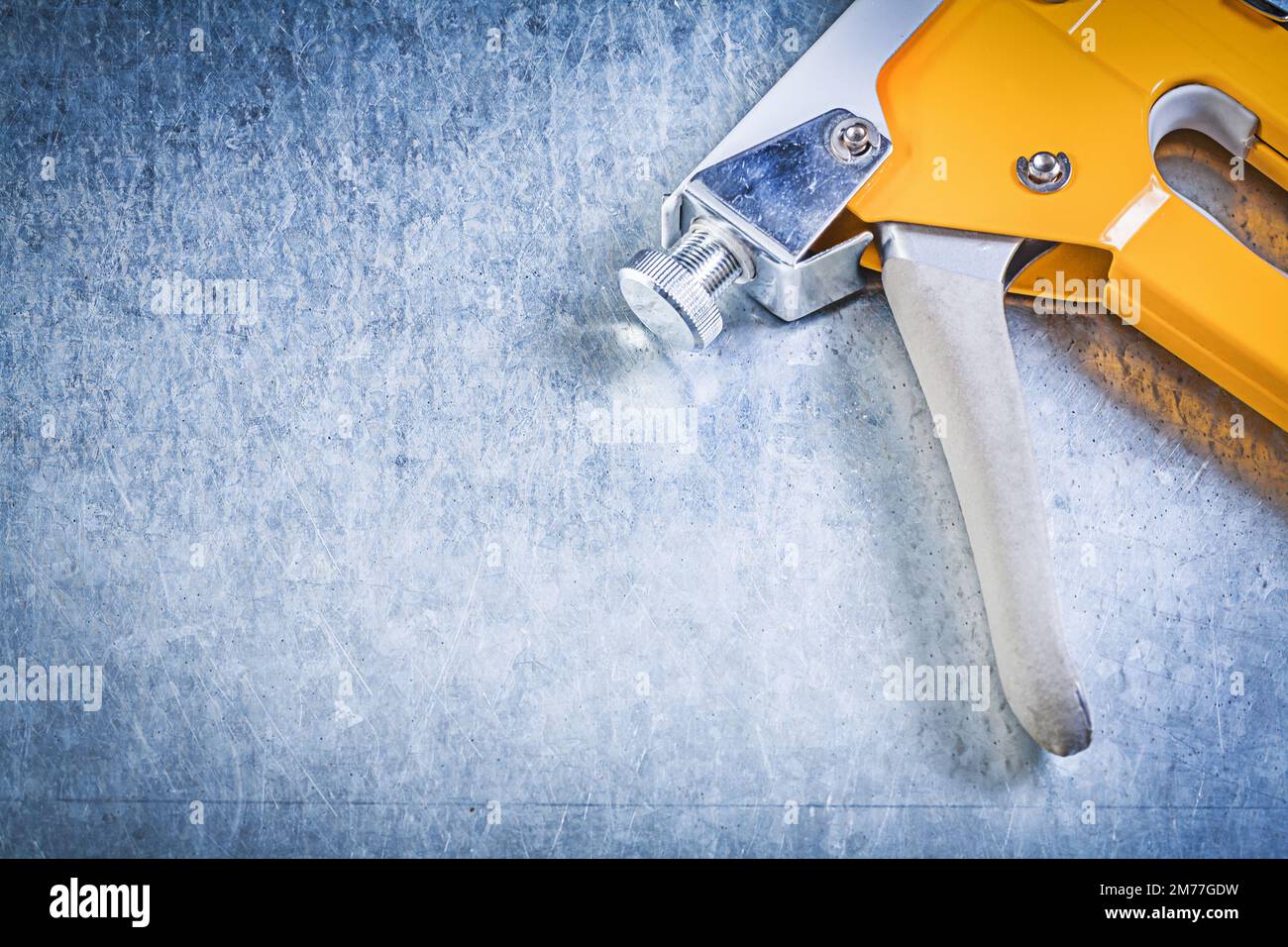 Stapler gun on metallic background copyspace Stock Photo - Alamy