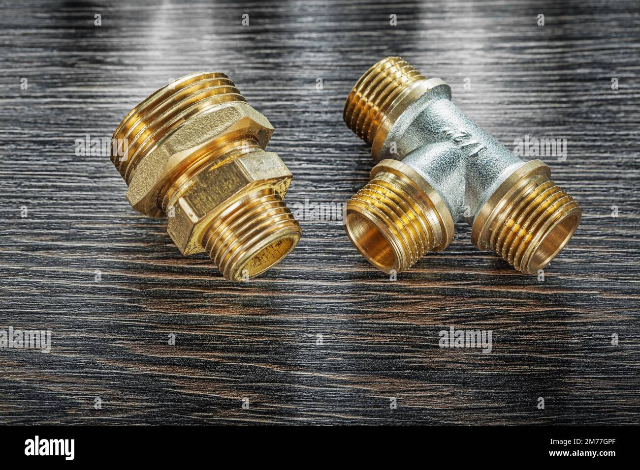 T-tube pipe connector threaded fitting on vintage wooden board Stock ...