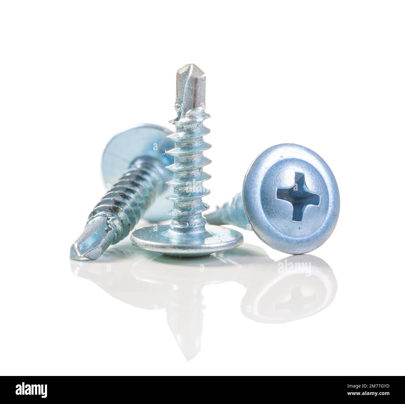 Three small screws isolated macro Stock Photo - Alamy