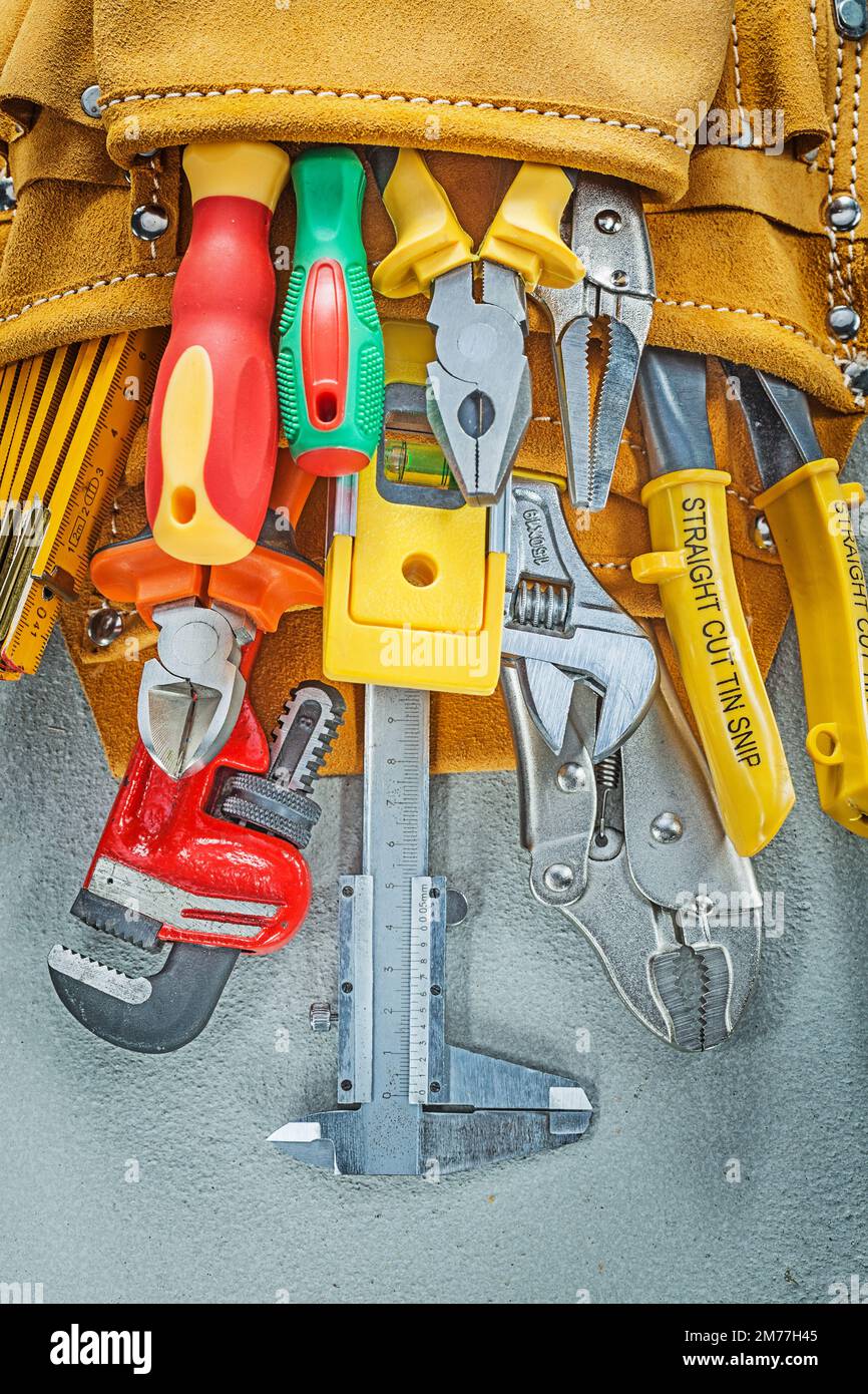 Tool belt construction tooling on concrete background Stock Photo - Alamy