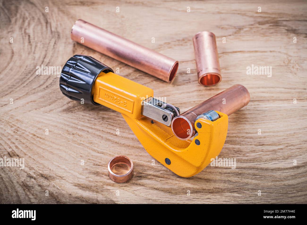 Top view of brass water pipe cutter on wooden board plumbing concept ...
