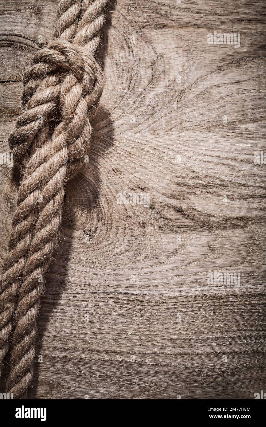 Twisted firm jute rope bend on wooden board Stock Photo - Alamy