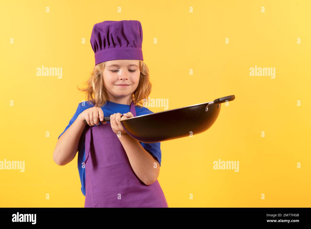 Kid cook with cooking pan. Chef kid preparing healthy food. Portrait of ...