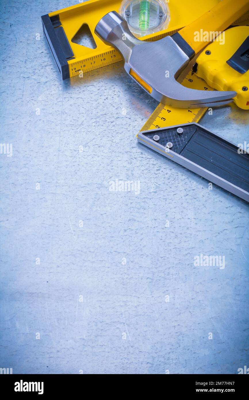 Vertical view of claw hammer tape measure construction level square ...