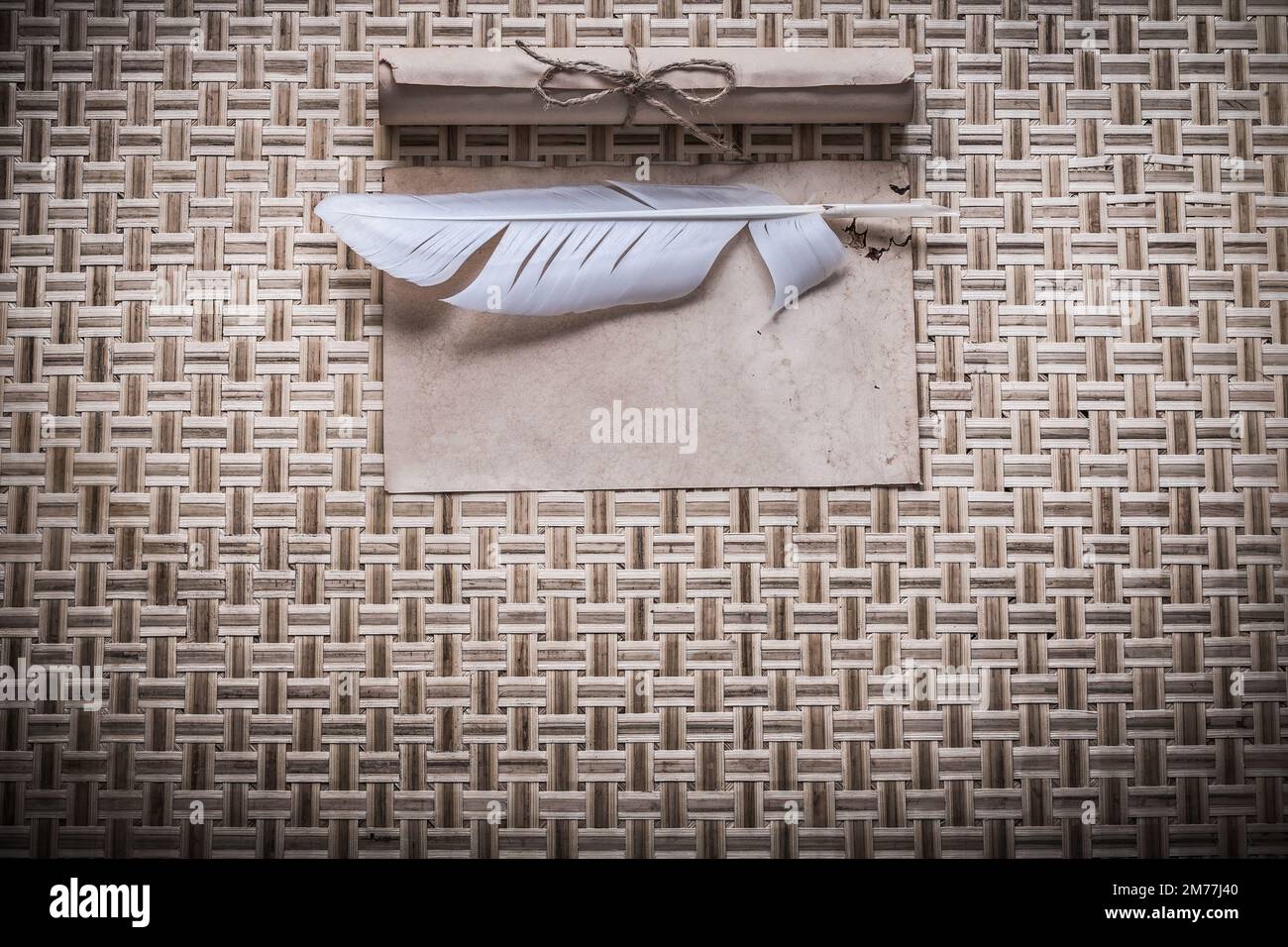 Vintage clean sheet paper roll plume on woven wooden matting Stock ...