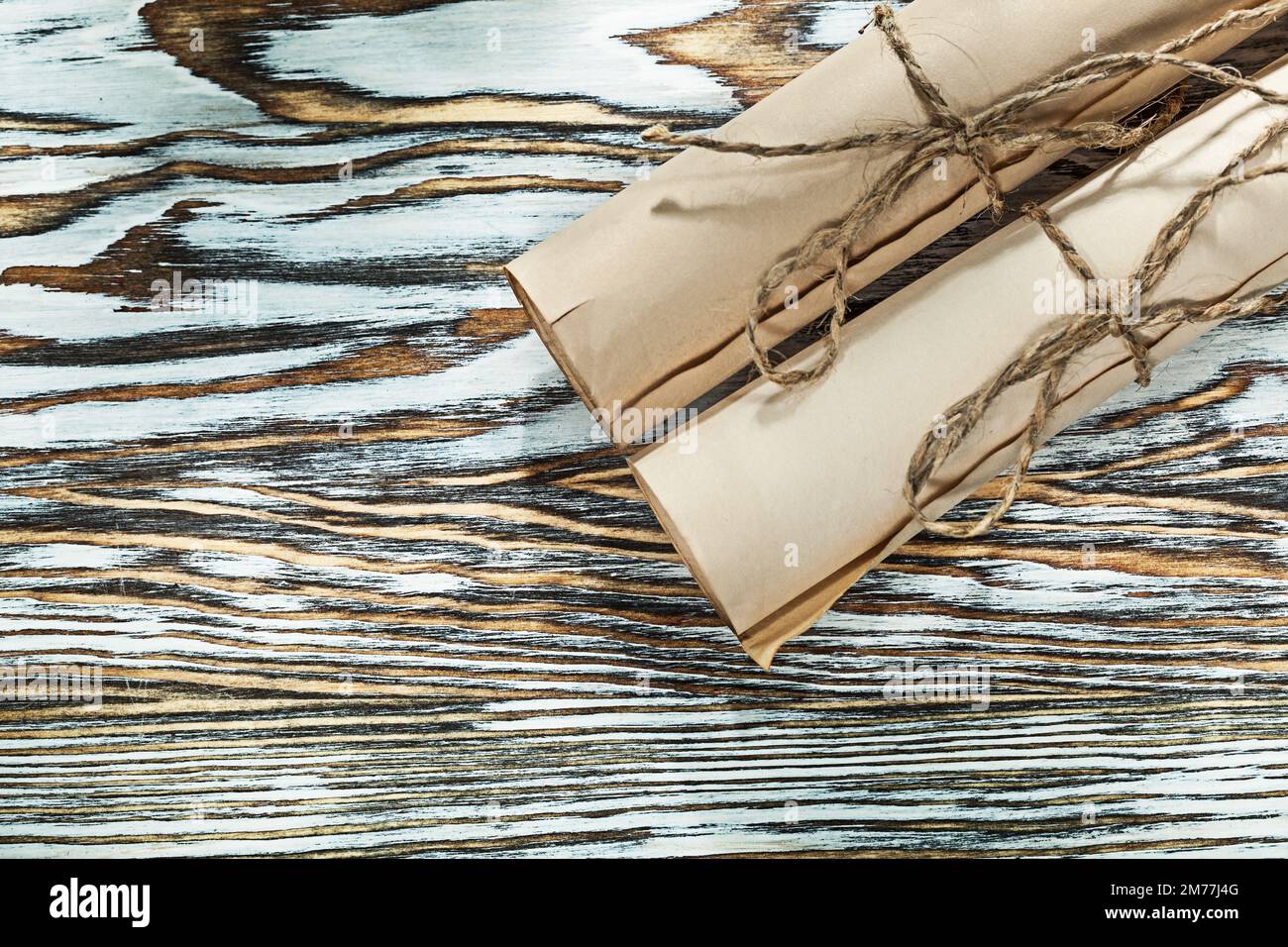 Vintage corded paper rolls on wooden board Stock Photo - Alamy