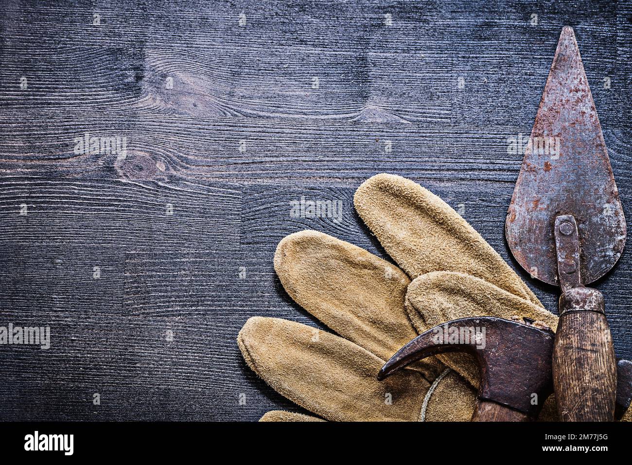 vintage dusted and rusted tools hammer and spattle on glove Stock Photo ...