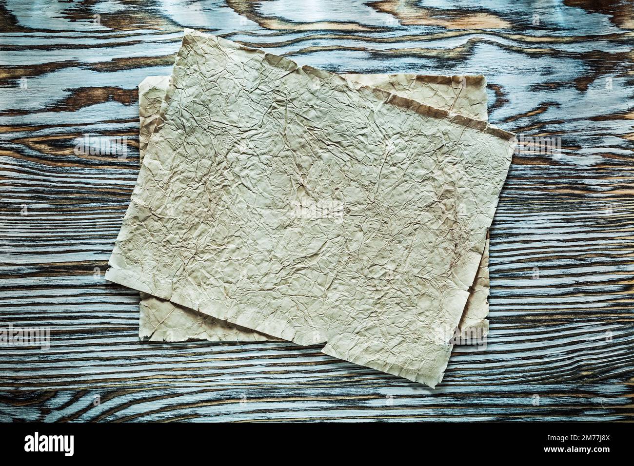 Vintage crumpled paper roll on wooden board top view Stock Photo - Alamy