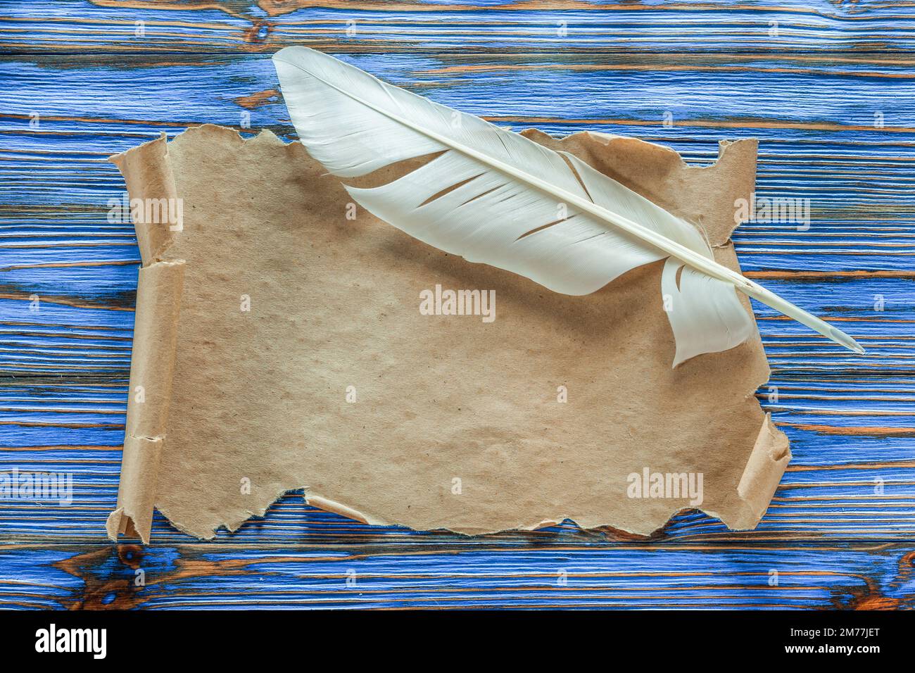 Vintage paper scroll plume on blue wooden board Stock Photo - Alamy