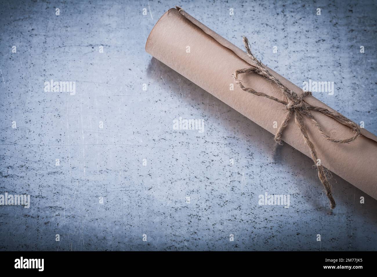 Vintage rolled corded parchment on scratched metallic surface Stock ...